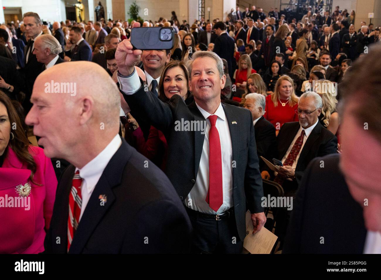 Georgia Governor Brian Kemp (R) is seen in an overflow room for President-elect Donald Trump's ...