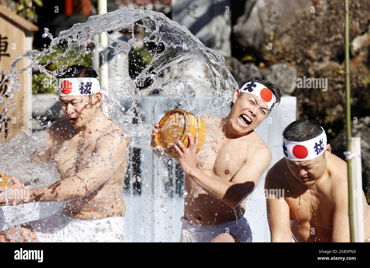 Men splash themselves with icy water during a winter purification ...