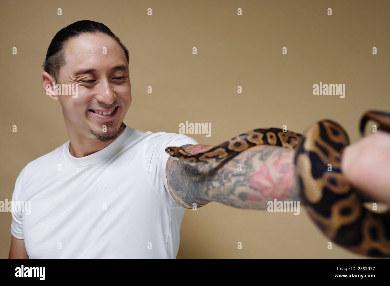 Smiling Man Handling Snake Wearing White Shirt Stock Photo - Alamy