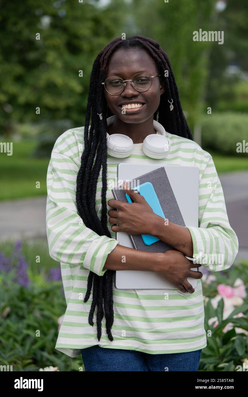 Happy university african american student with dreadlocks and ...