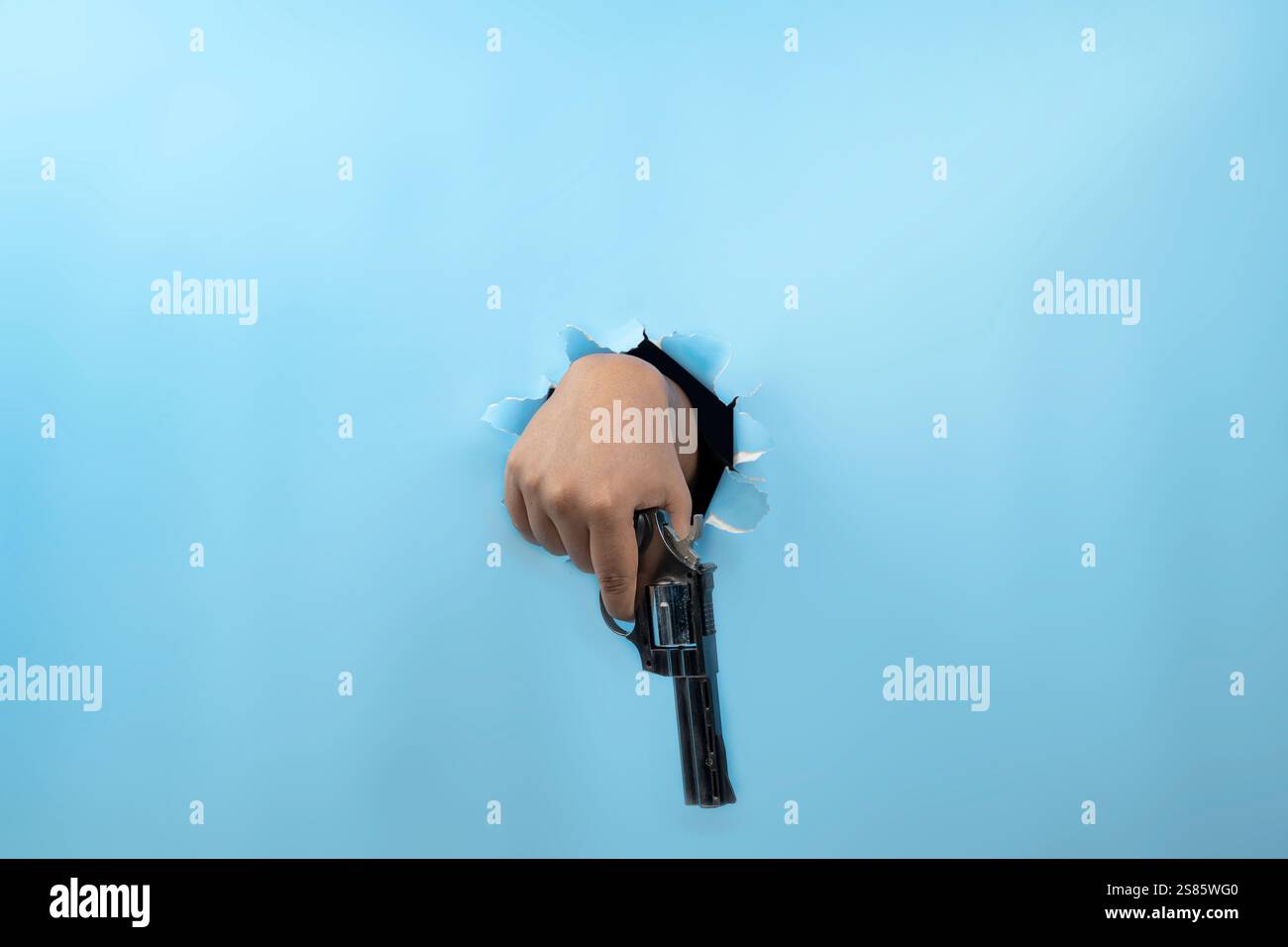 Human hand holding handgun through ripped paper. Hand gestures. Mockup ...