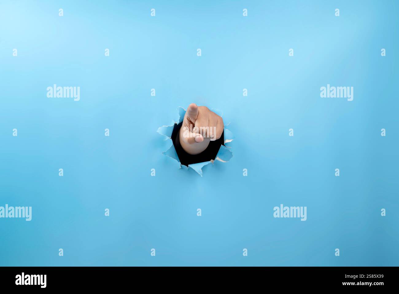 Human hand showing from ripped paper. Hand gestures of pointing. Mockup ...