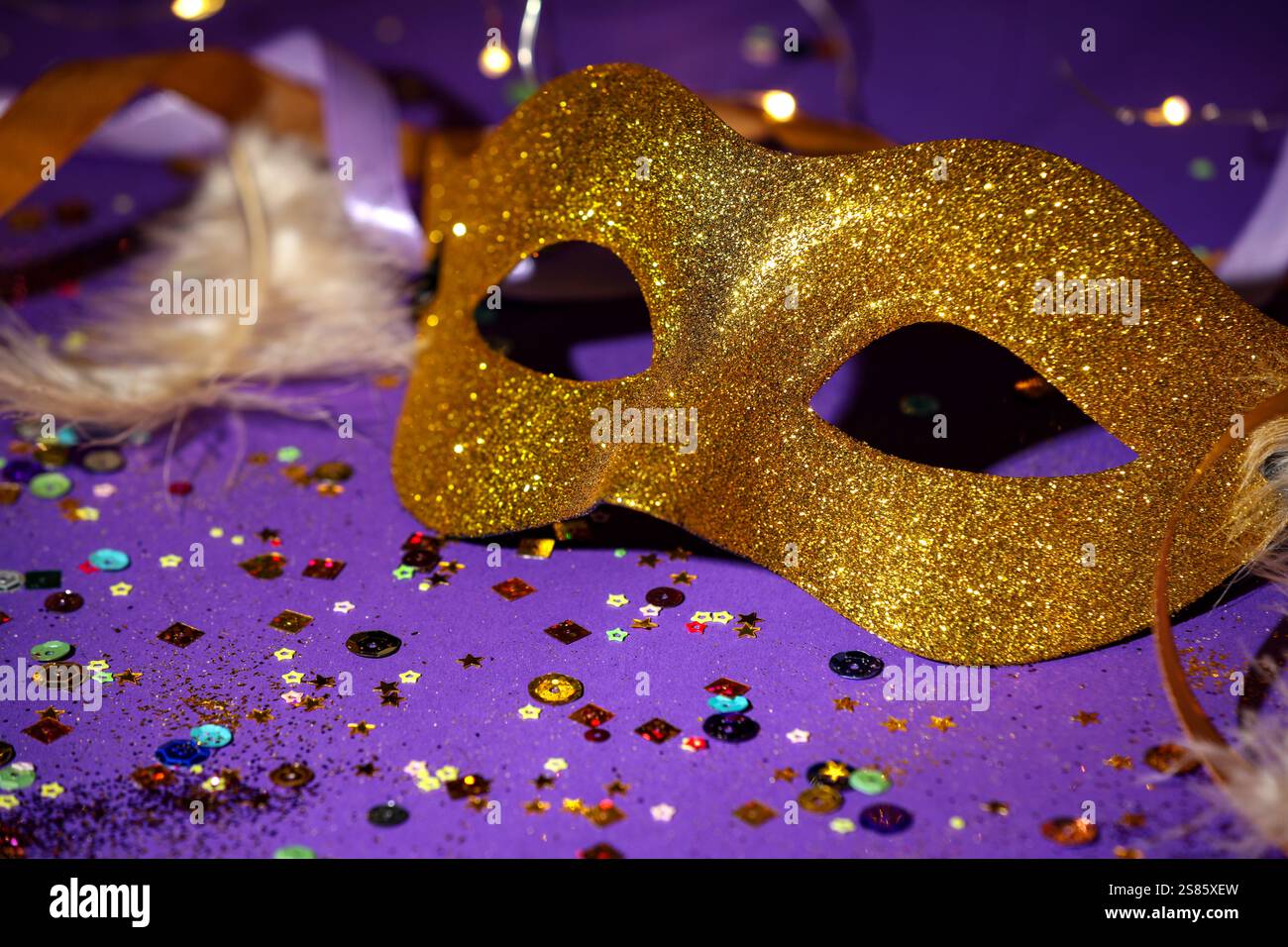 Beautiful carnival mask, ribbons and confetti on purple background ...