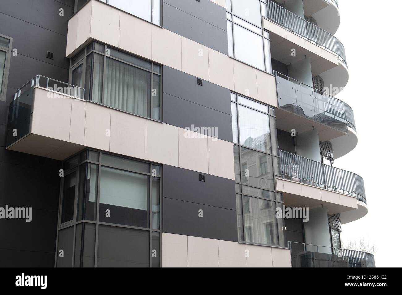 A modern duplex with a simple, sleek exterior design, featuring clean ...