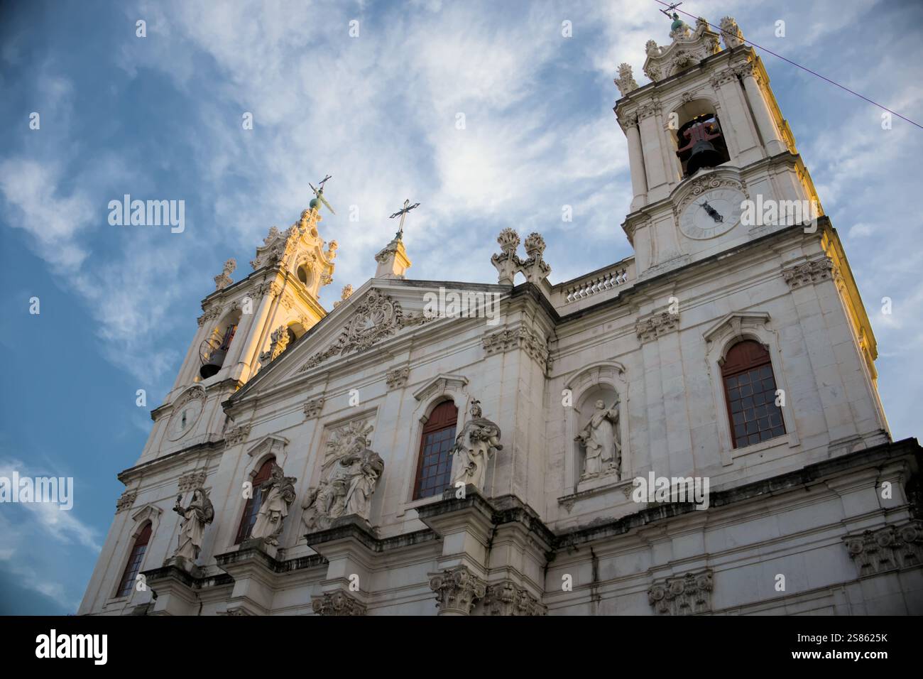 Ground up view of the Basilica da Estrella with a cloudy evening sky ...