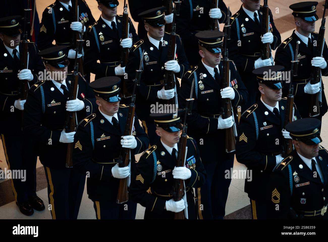 Members of the military stand as President Donald Trump reviews the ...
