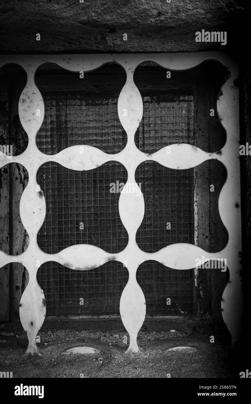 Architectural detail highlighting a vintage metal grille with unique ...