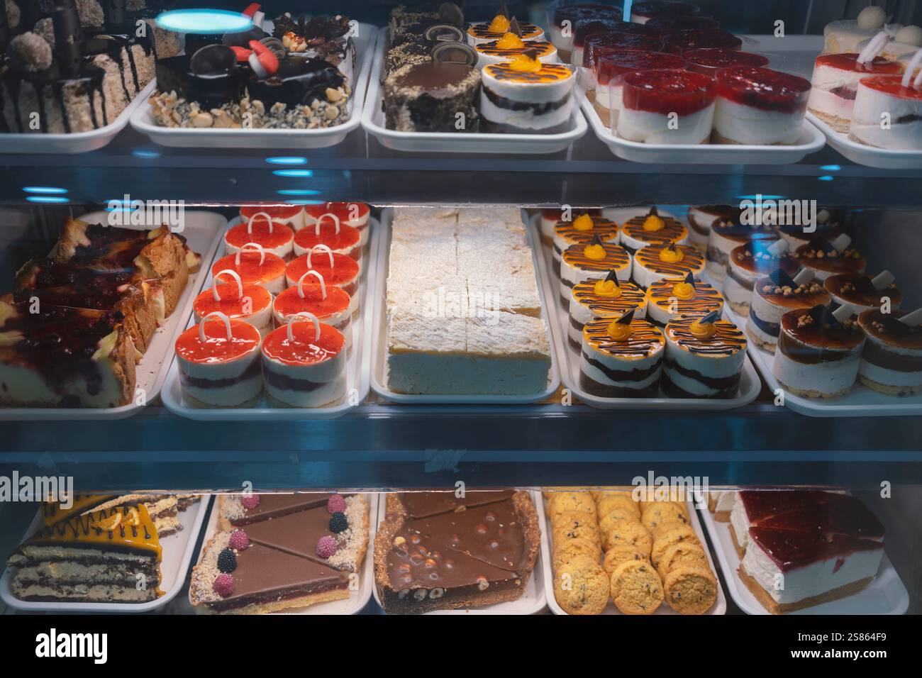Cakes in a display case, various types, close-up view Stock Photo - Alamy