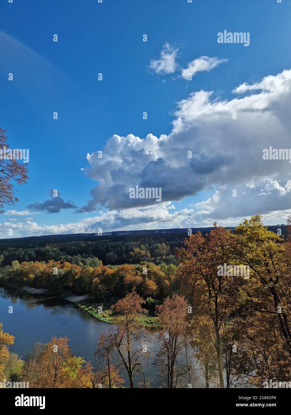 Autumn landscape of a river winding through a forest colored with ...