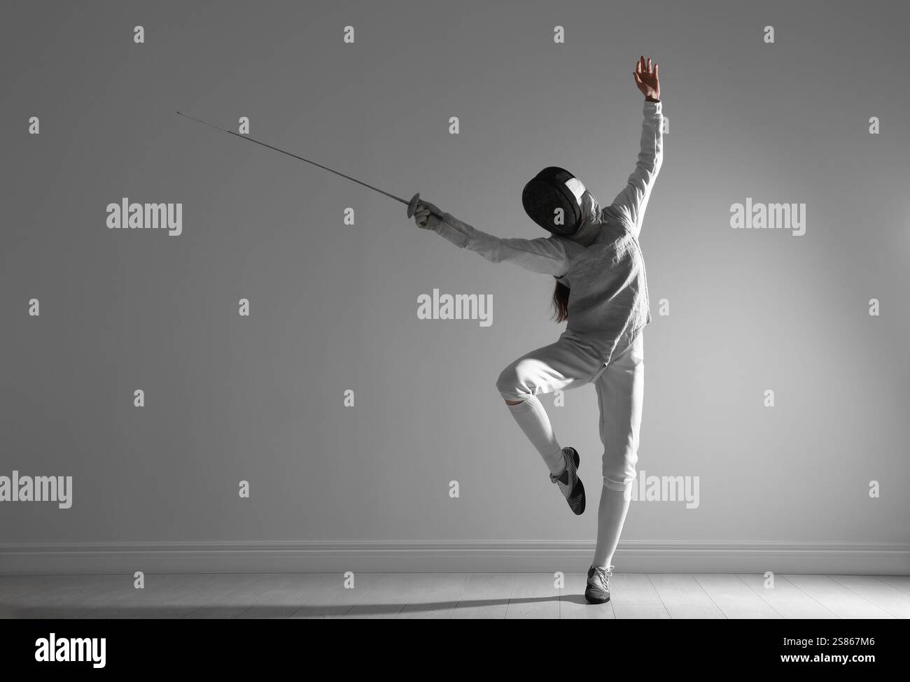 Fencer with epee practicing indoors. Combat sport Stock Photo - Alamy