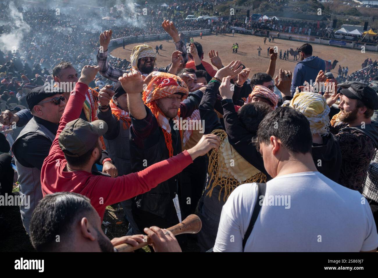 Spectators watching the wrestling have fun accompanied by drum and ...