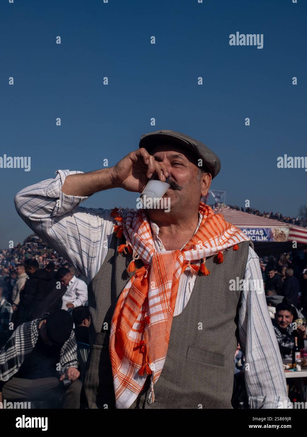A man dressed in a traditional nomadic costume drinks raki, a Turkish ...