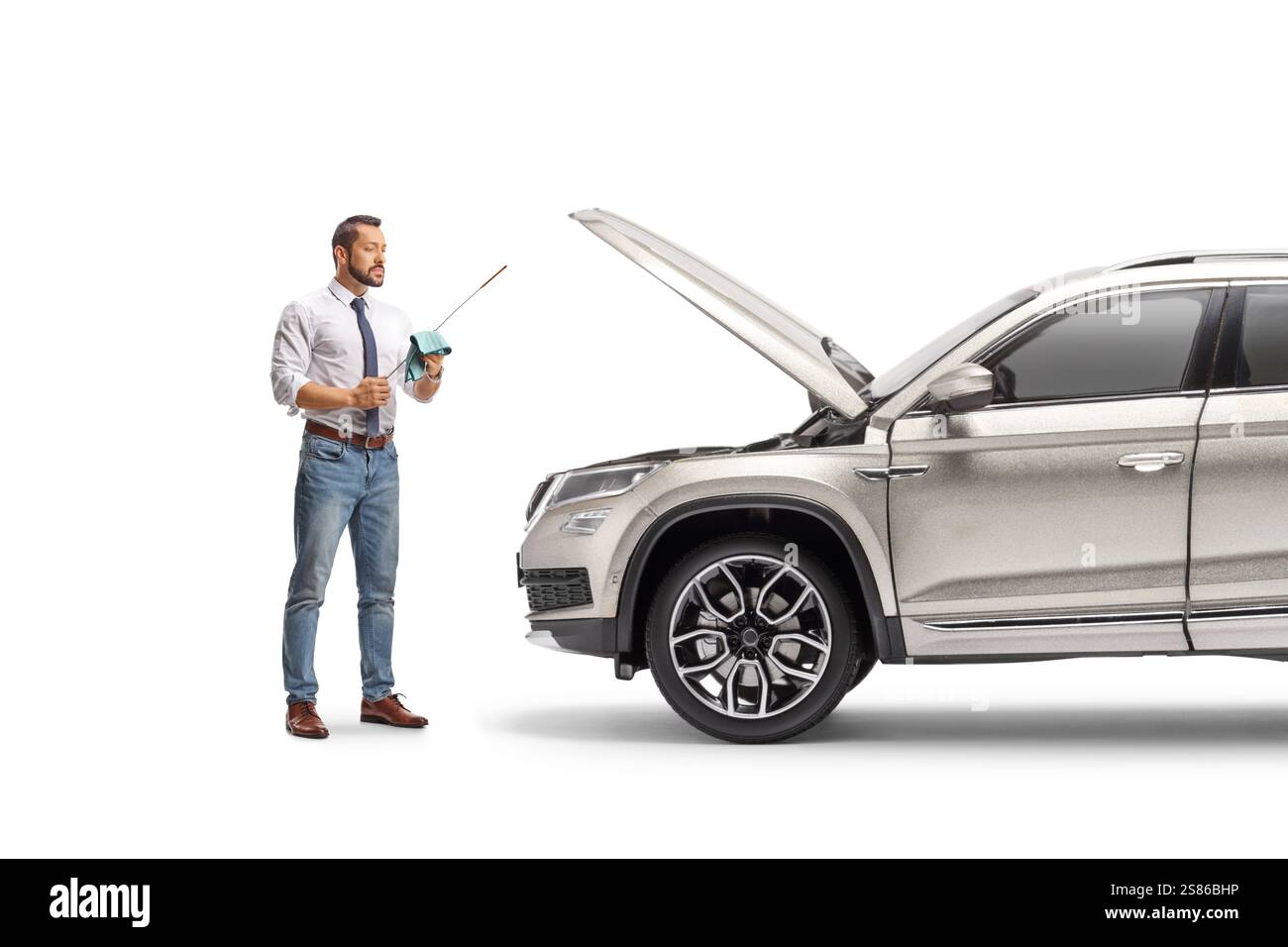 Man with a stick for engine oil check in front of a SUV with an open ...