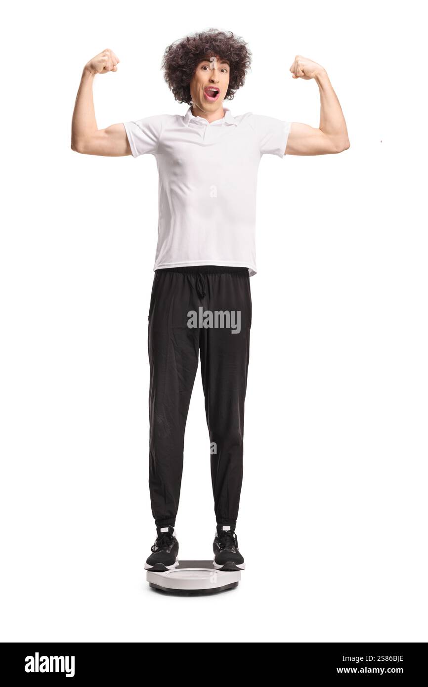 Young man in tracksuit showing arm muscles and standing on a weight ...