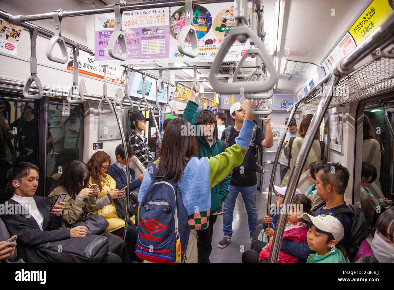 Commuters and travellers on an underground train in Tokyo, Japan Stock ...