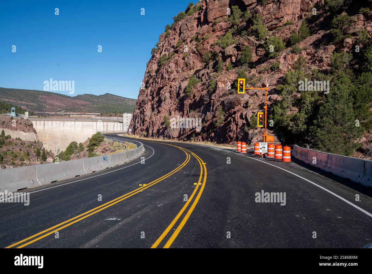 Single-lane construction temporary stoplight controls traffic at a dam ...