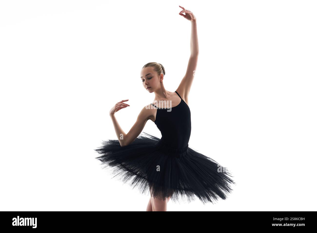 Portrait of a ballerina in a black tutu performing a classical ballet ...