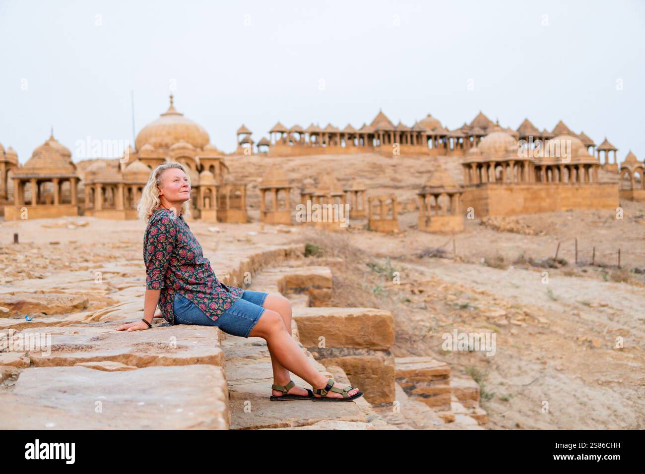 Blonde woman exploring historic Bada Bagh tombs made of sandstone in ...
