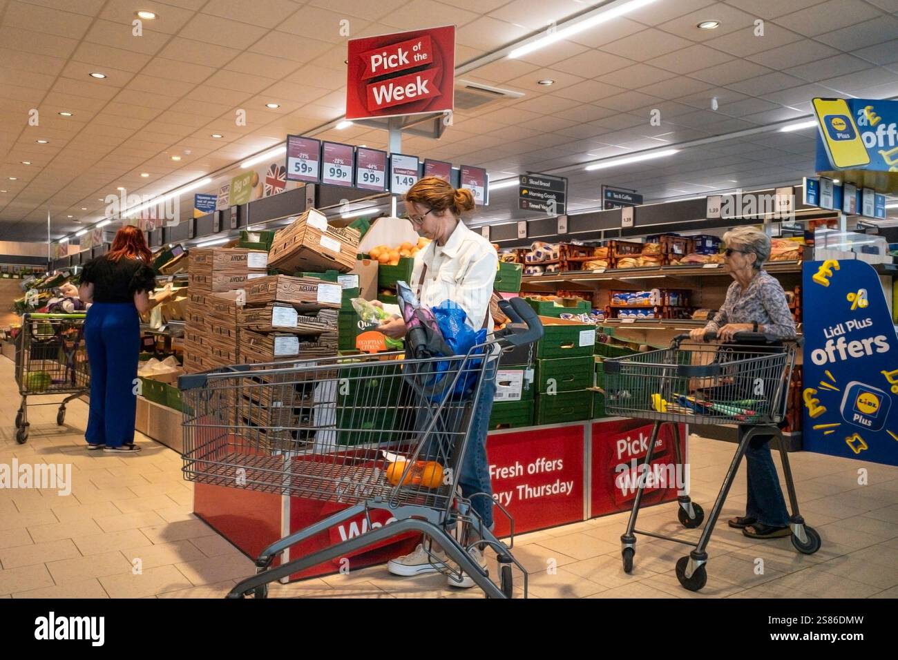 Shoppers customers people shopping inside a Lidl shop store in England ...