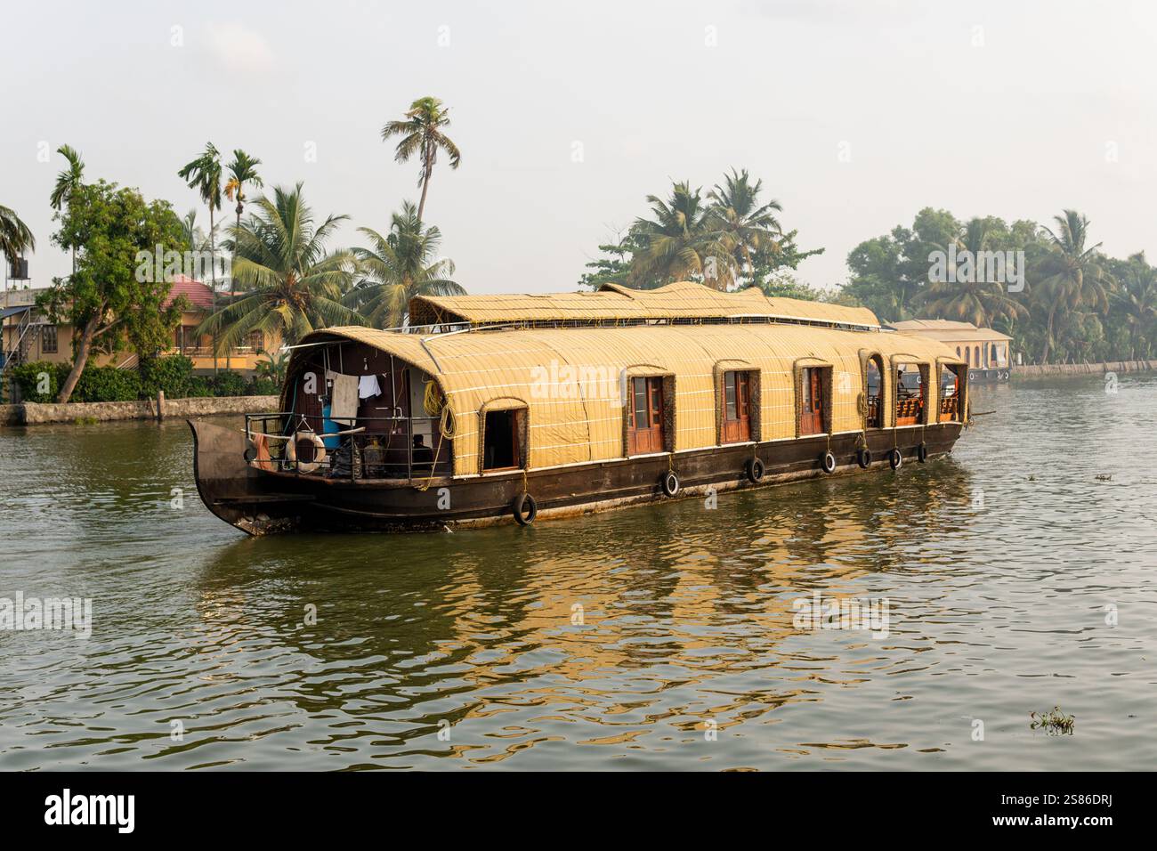 Traditional houseboat floating on the backwaters of Kerala, India. Eco ...