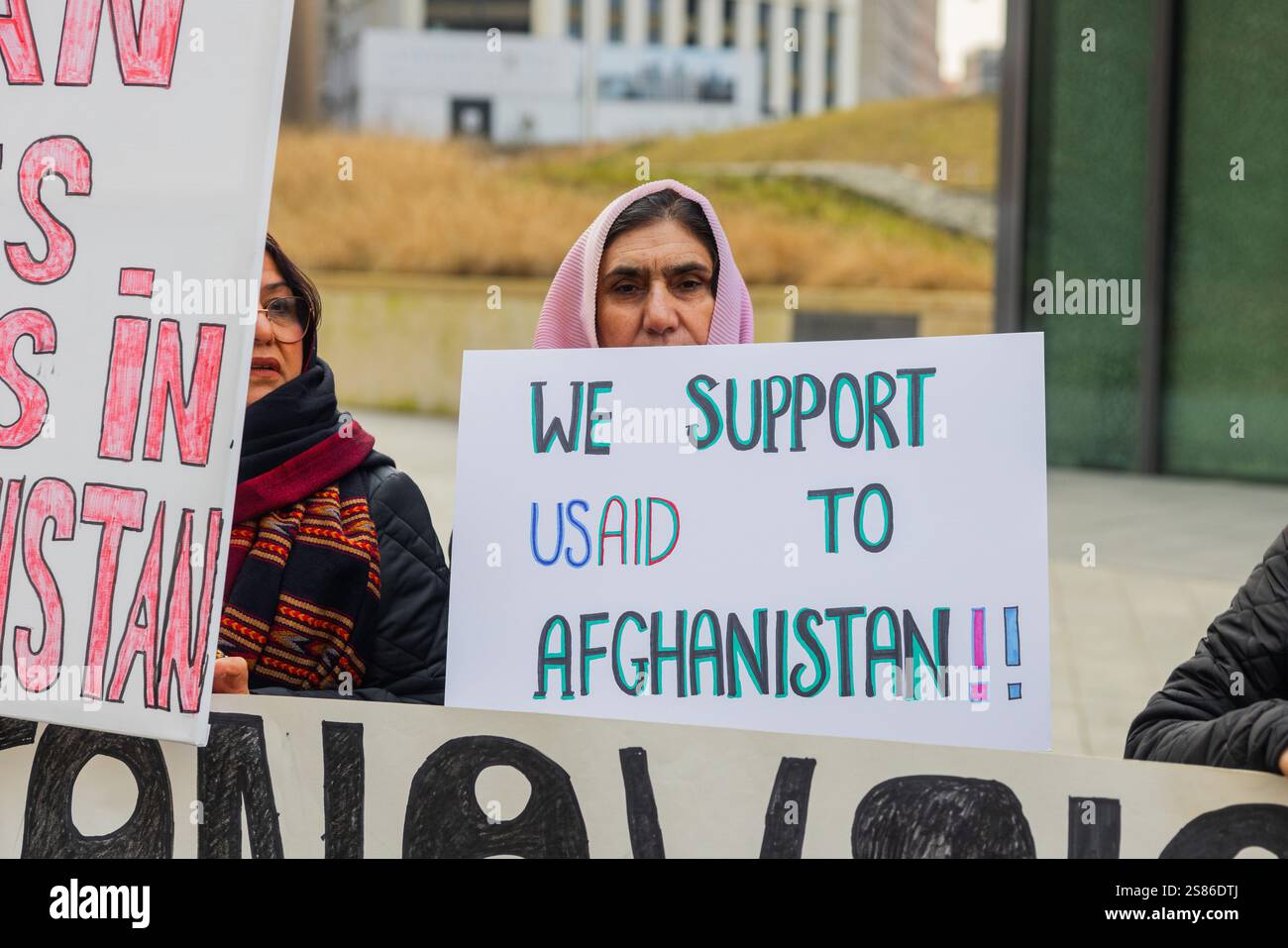 London, UK. 20 JAN, 2025. Woman holds "We support USaid to Afghanistan ...