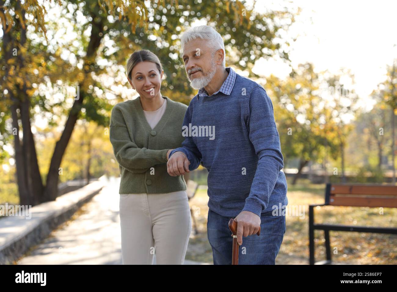 Caregiver assisting senior man in park. Home health care service Stock ...