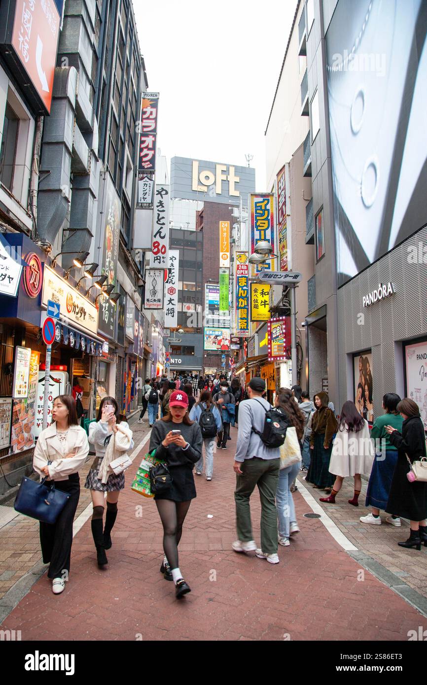 Crowded street scene in Shibuya shopping district in Tokyo, Japan with ...