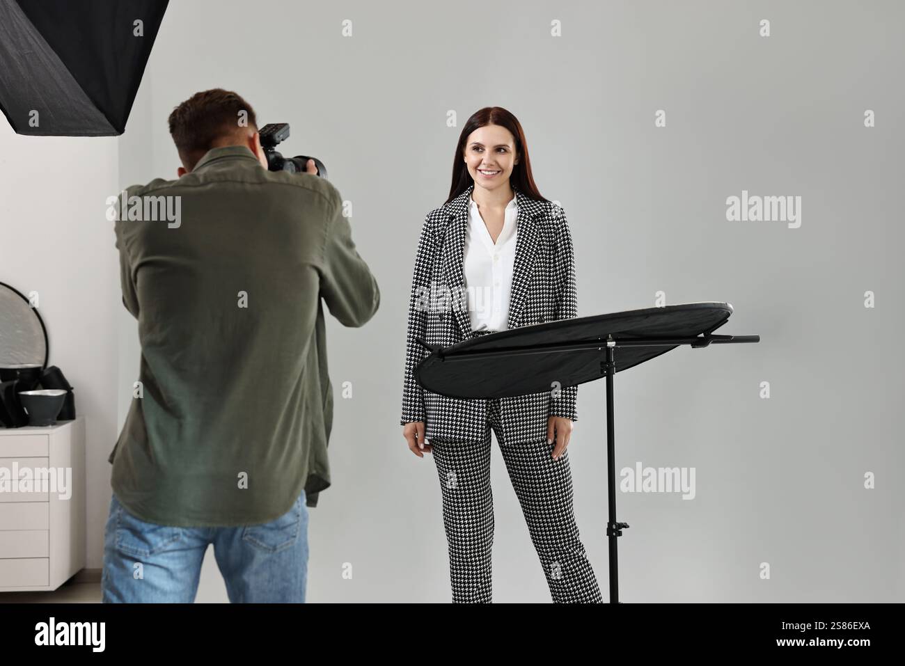 Photographer working with model in professional photo studio Stock ...