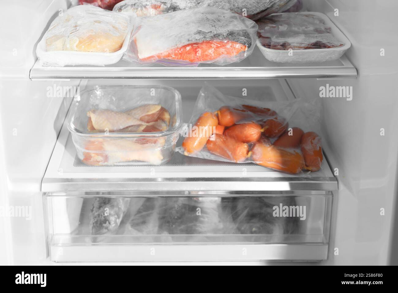 Different frozen meat and fish products in fridge Stock Photo - Alamy