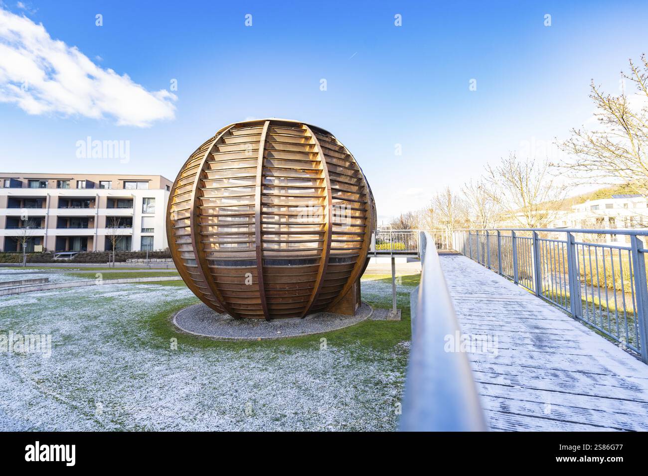 Wooden ball with surrounding wooden path, hint of snow, clear sky ...