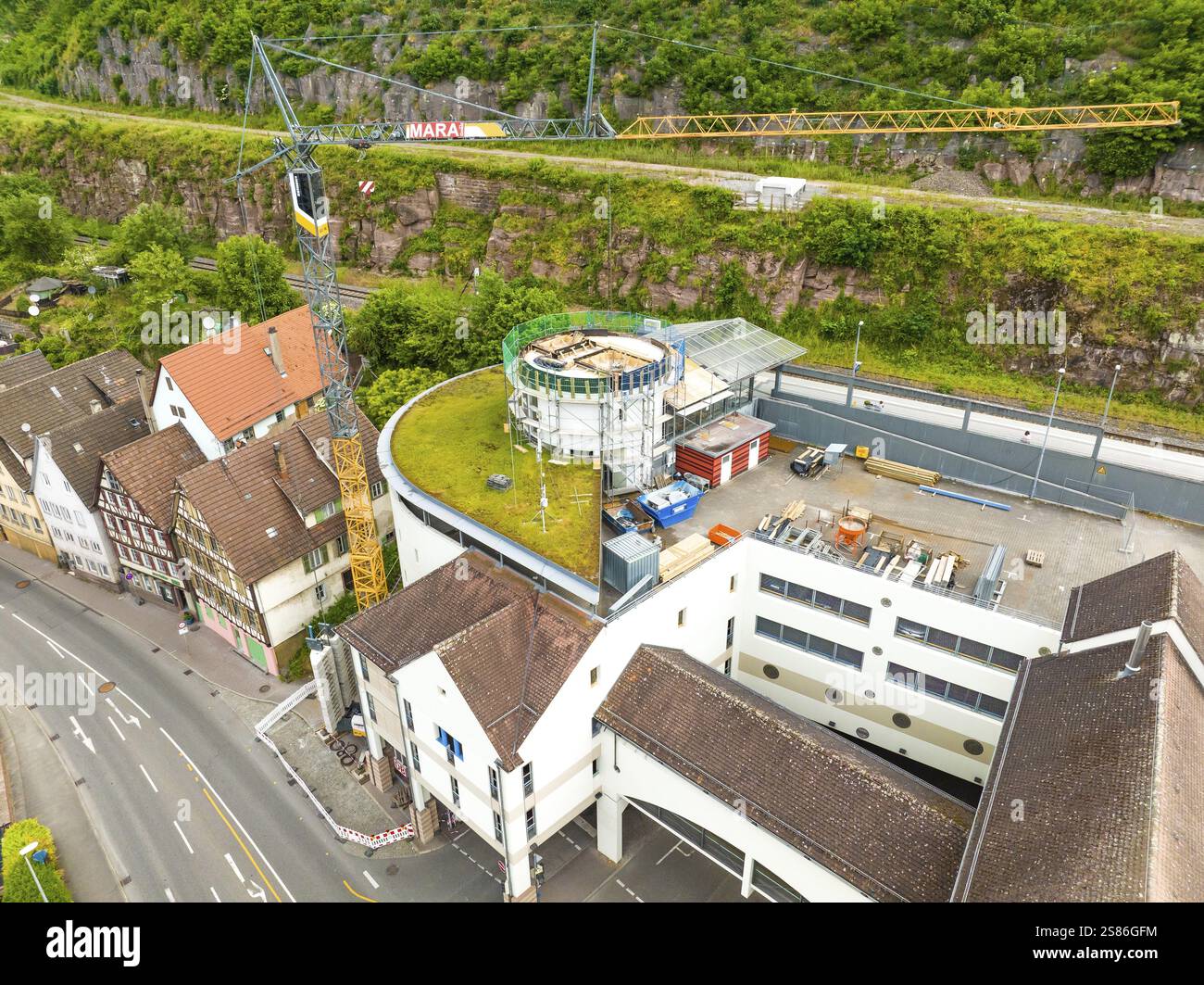 Aerial view of a building with green roof and crane in an urban ...