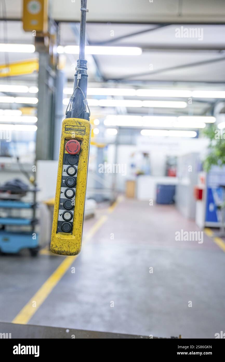 Yellow remote control for hoists in industrial environments with bright ...
