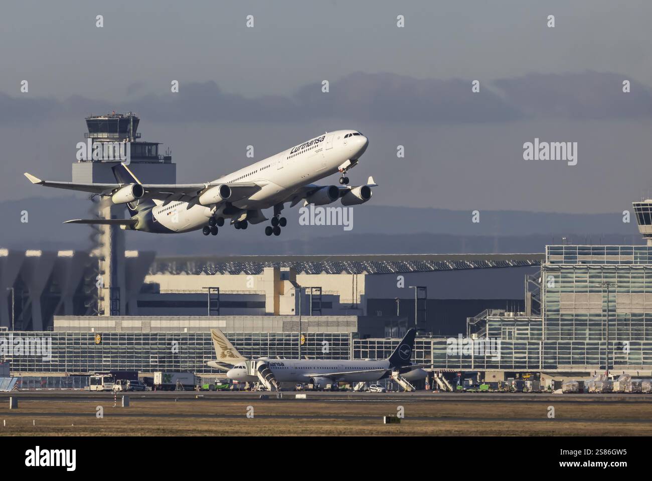 Aircraft takes off in front of the terminal and tower at Fraport ...
