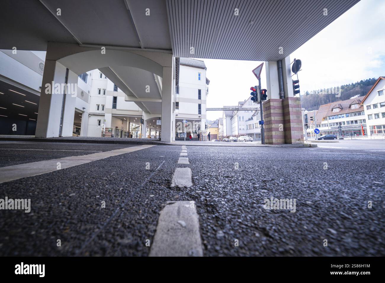 Street scene in an urban environment with buildings and bridges, car ...