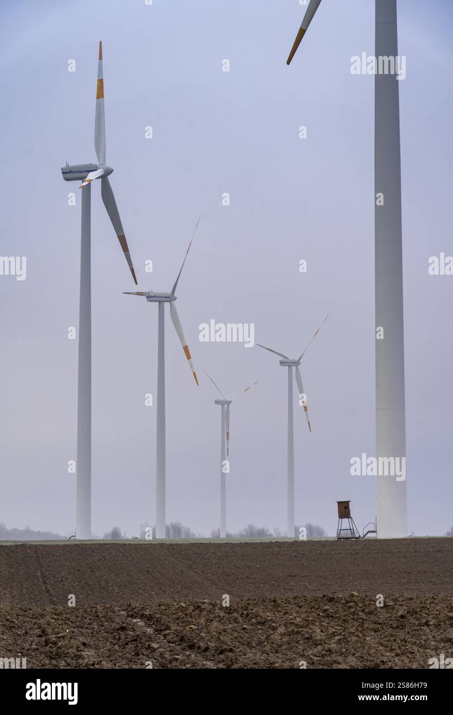 Wind farm in fog, dark doldrums, no wind no direct sunlight, in the ...