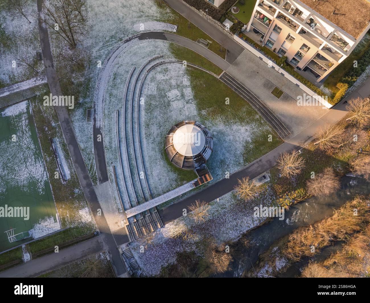 Aerial view of a park with wooden ball in the centre, surrounded by ...