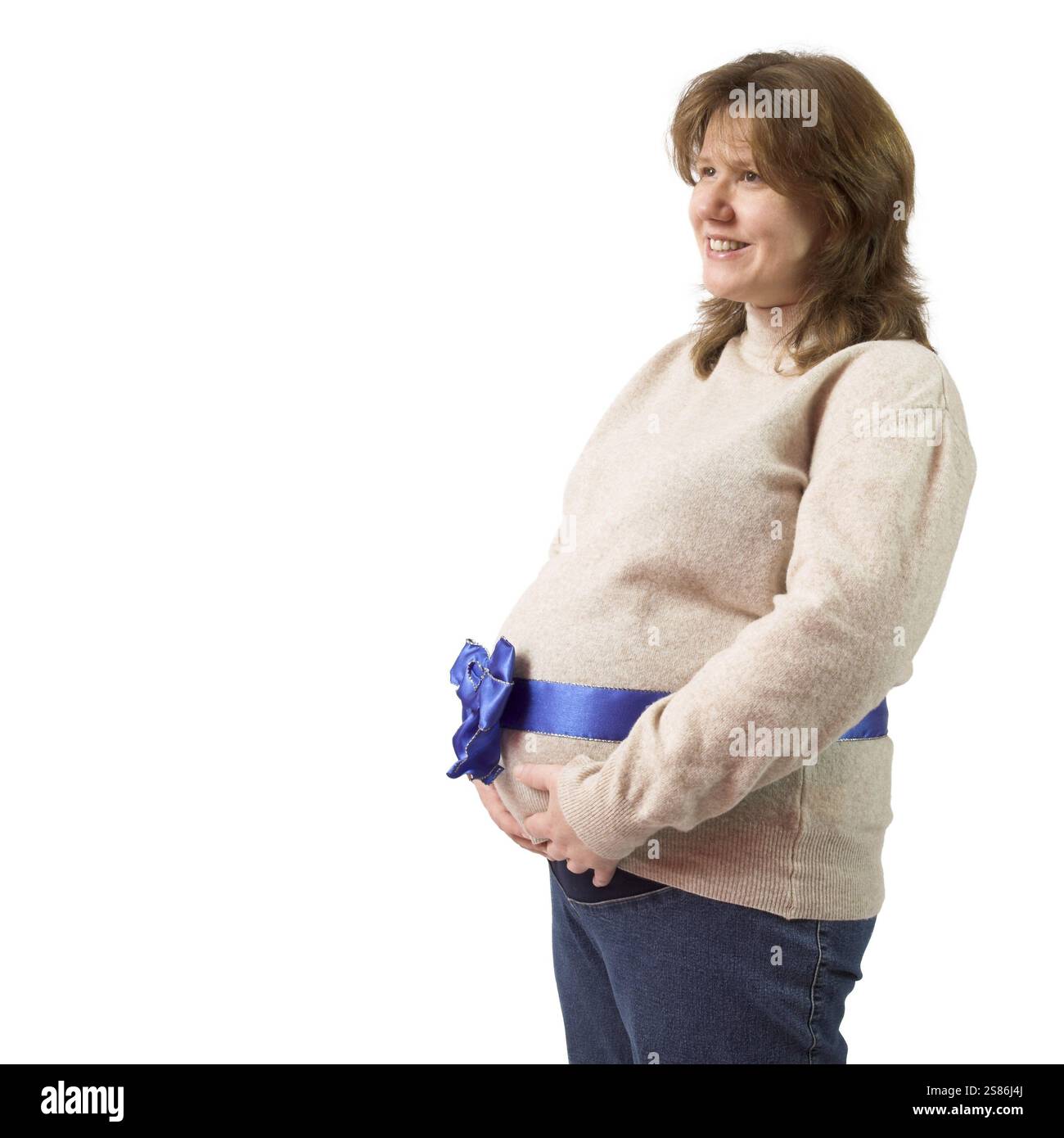Future mother holding her belly, blue ribbon with a bow across her ...