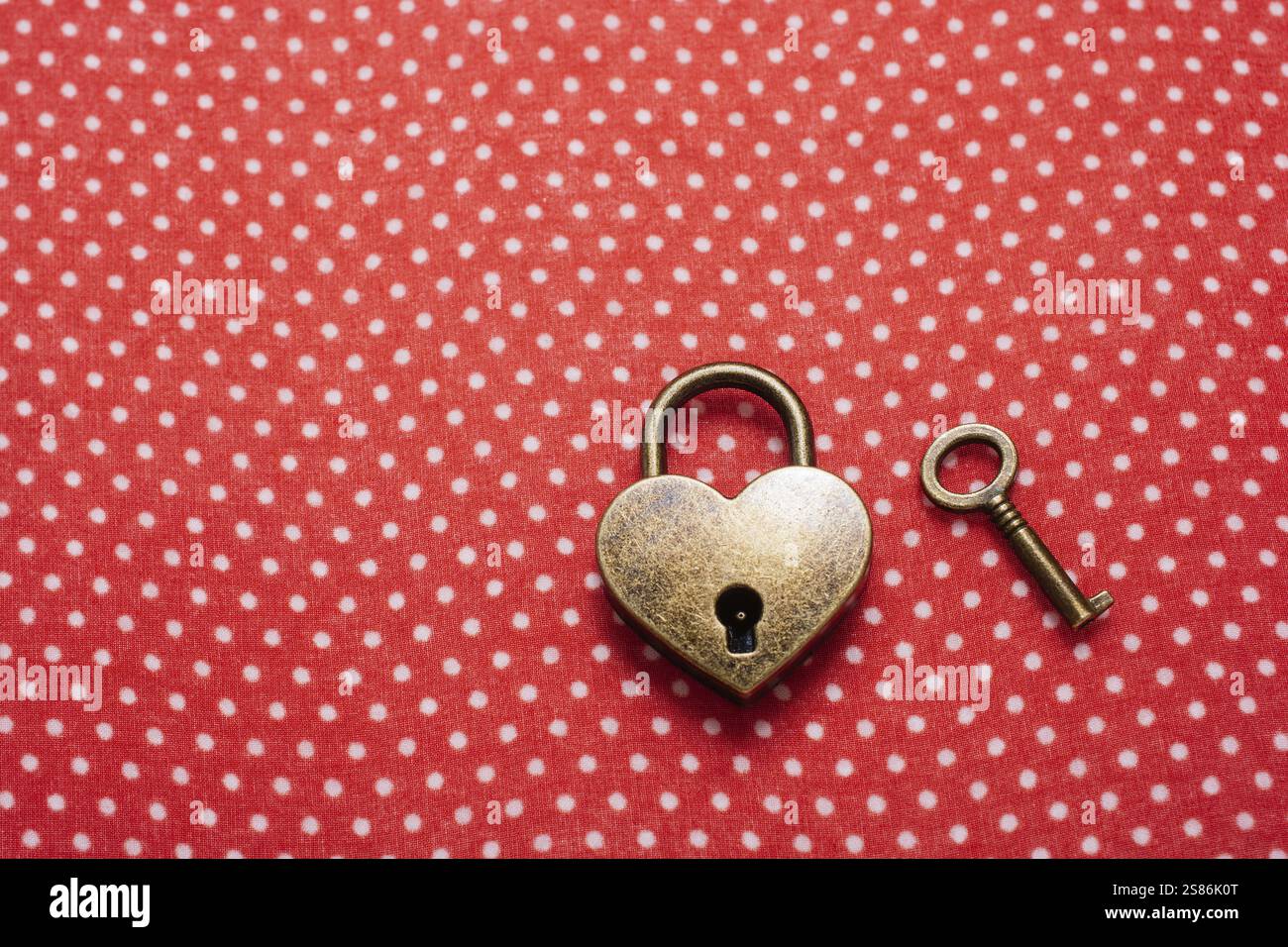 Heart shaped lock and key on a red background Stock Photo - Alamy