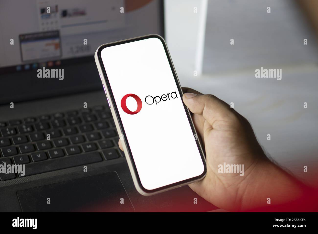 Opera logo is displayed on smartphone. Opera is a multi-platform web ...