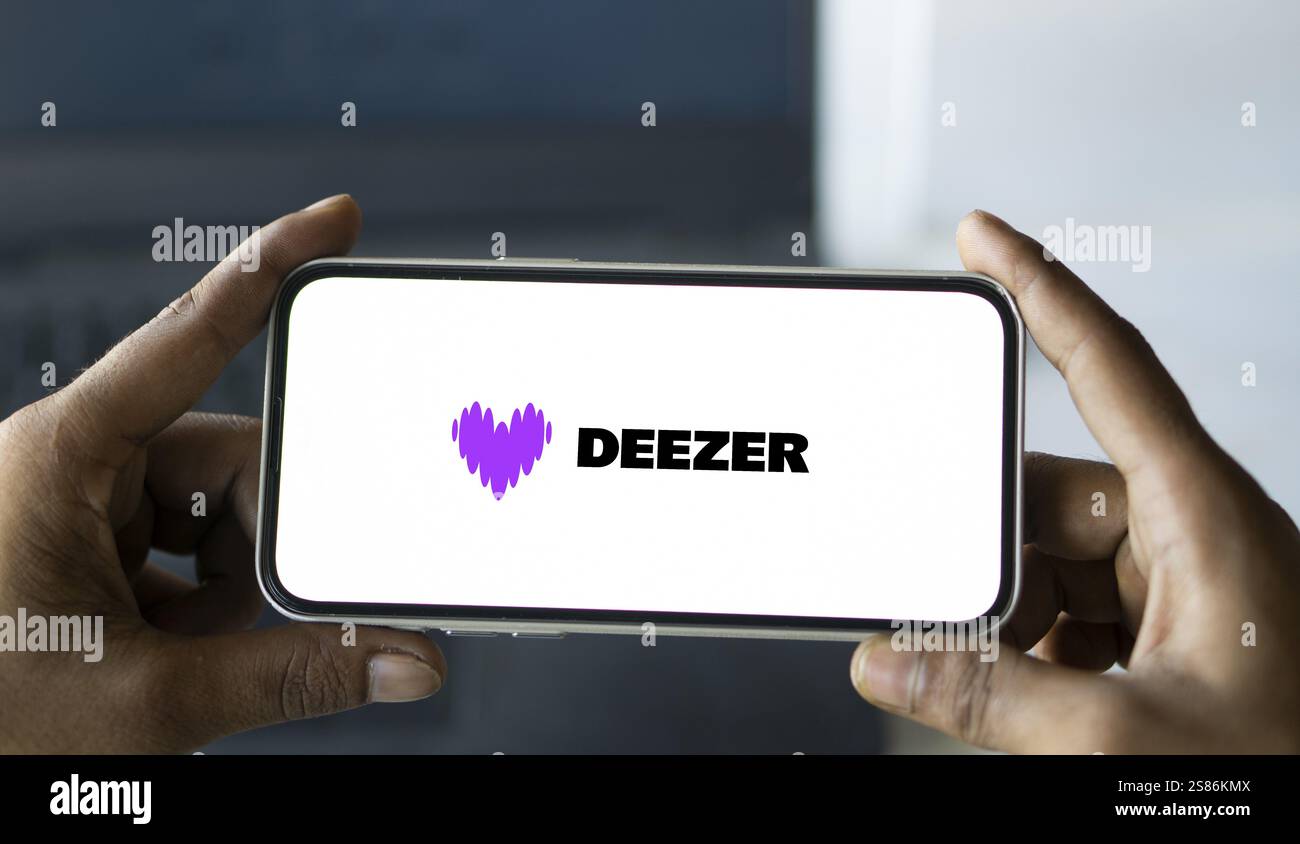 deezer logo is displayed on smartphone. Deezer is a French music ...