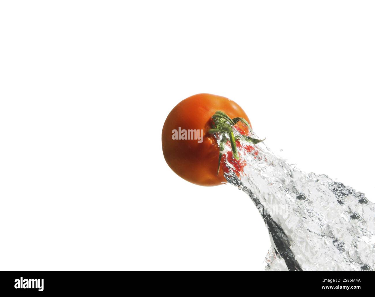 Tomato flying out of the water Stock Photo - Alamy