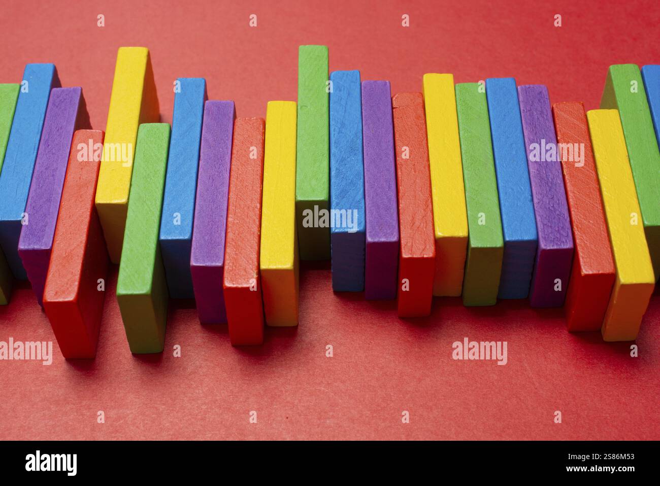 Colorful dominoes. Rainbow colored chain reaction Stock Photo - Alamy