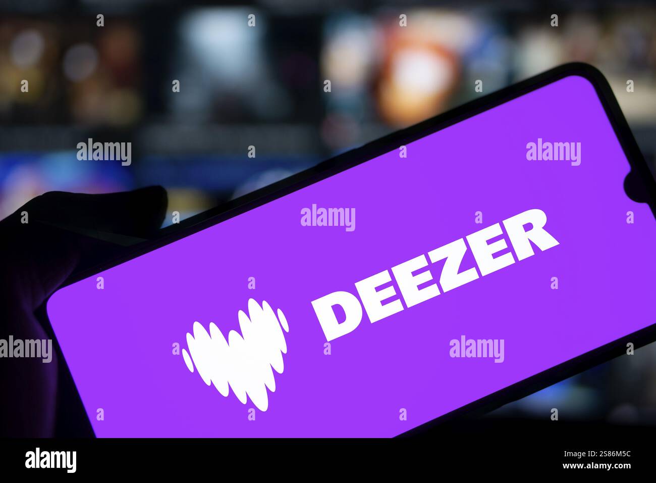 deezer logo is displayed on smartphone. Deezer is a French music ...