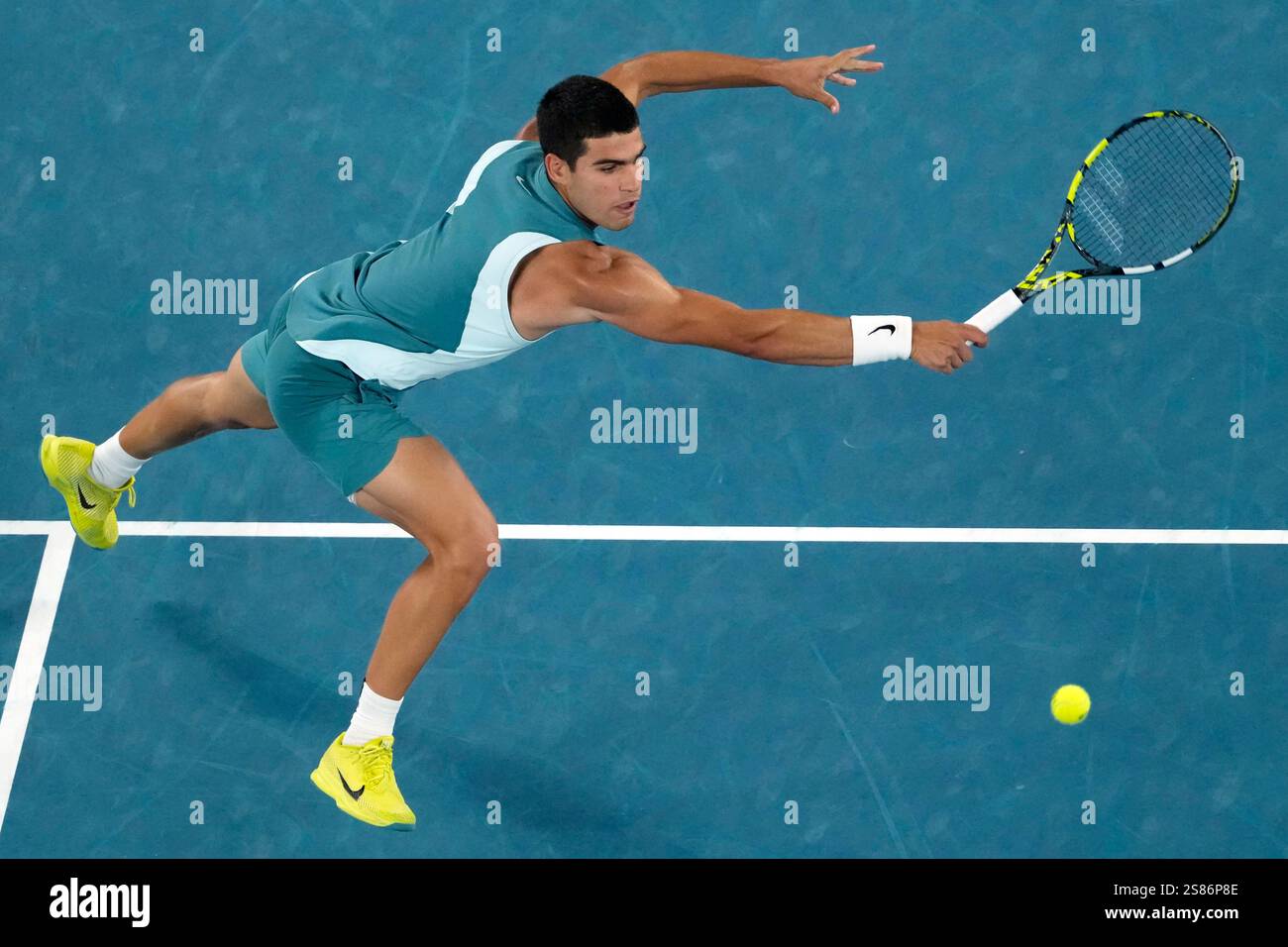 Carlos Alcaraz of Spain plays a backhand return to Novak Djokovic of ...