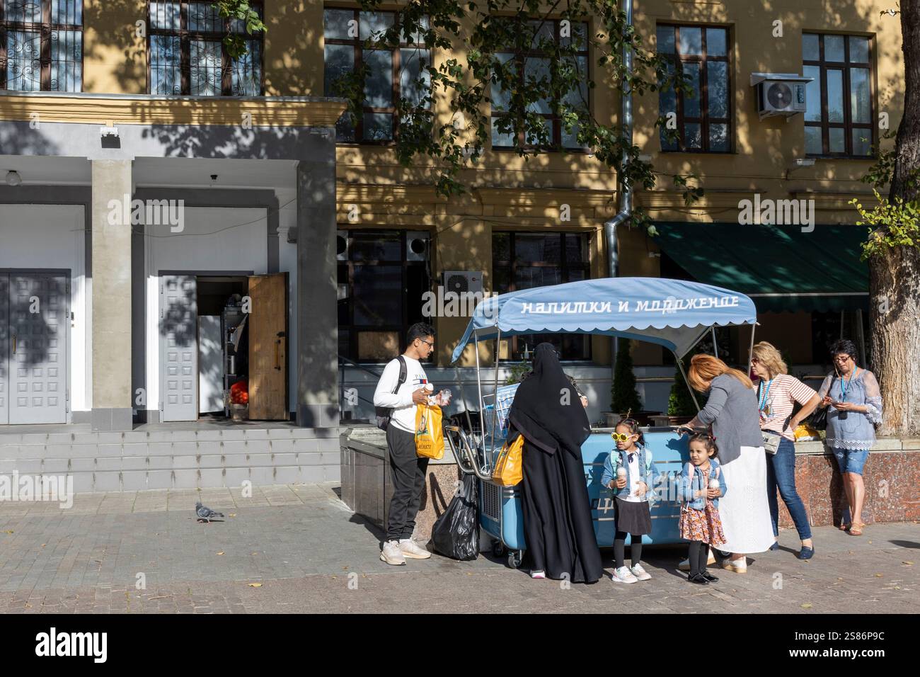 Moscow, Russia - August 25, 2025, A woman in a hijab is buying ice ...