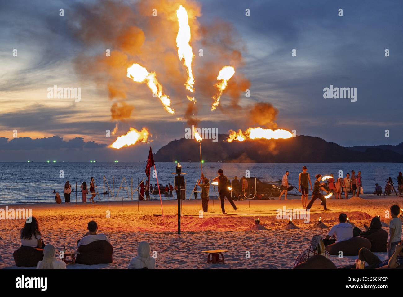 Fire show in the evening, people watching, on the sandy beach, Chenang ...