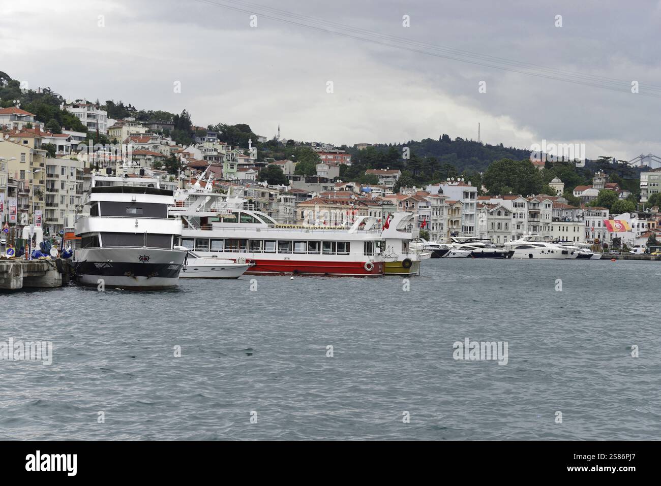 Ships at the pier of a busy coastal town, cloudy sky, water, Istanbul ...