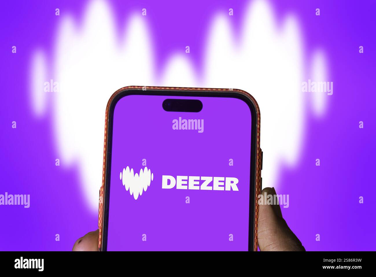 deezer logo is displayed on smartphone. Deezer is a French music ...