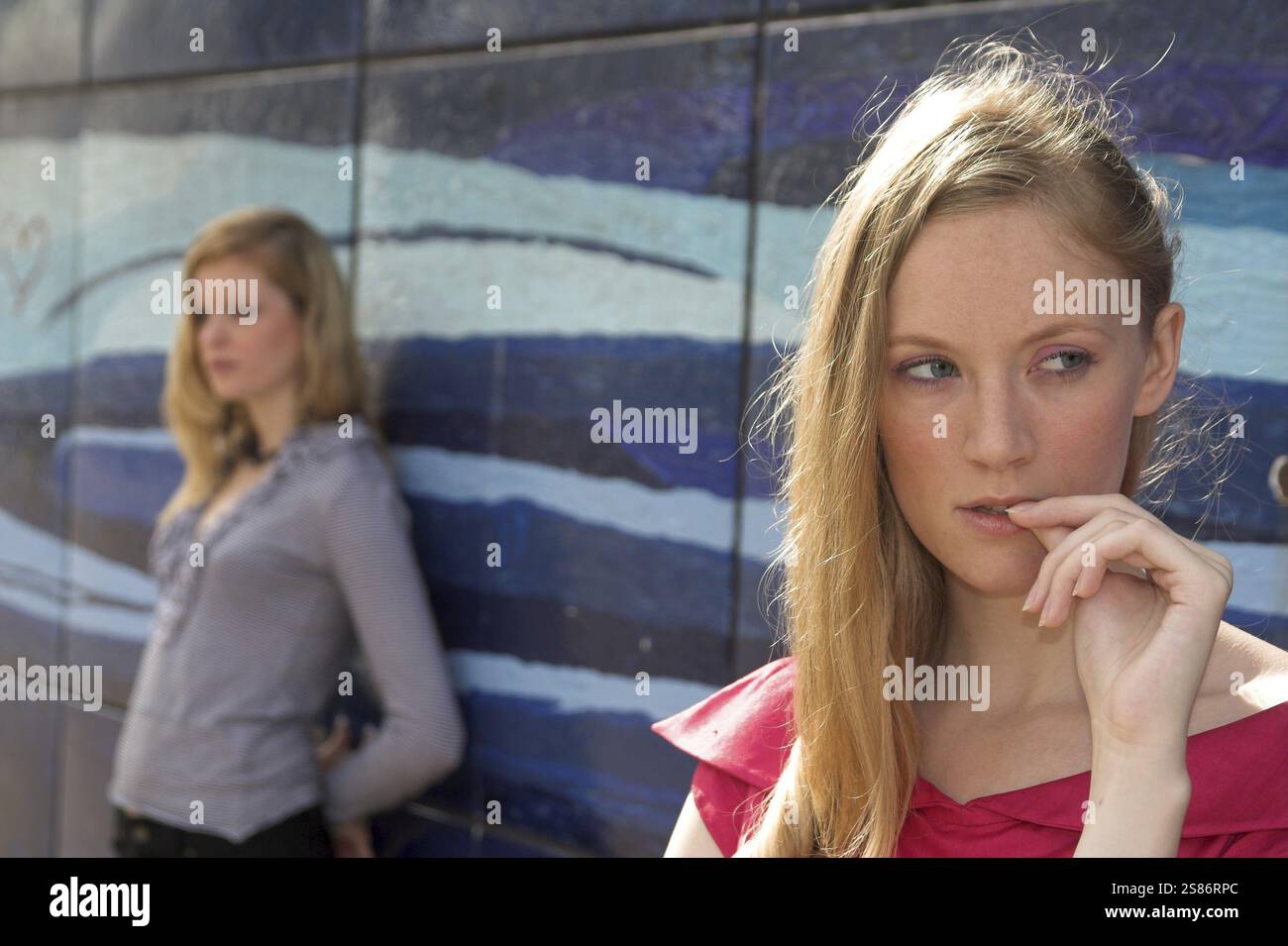 Two pretty adult girls have fallen out Stock Photo - Alamy