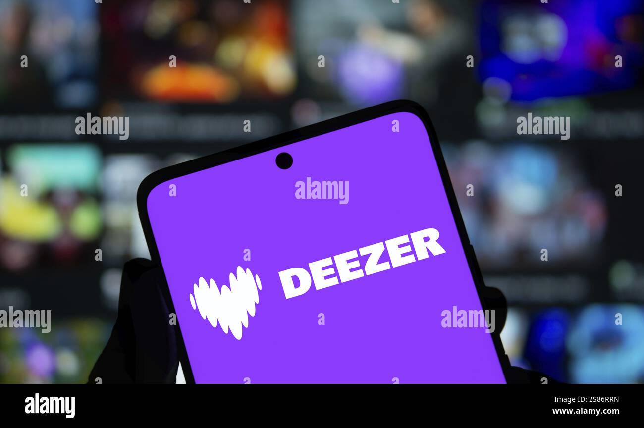 deezer logo is displayed on smartphone. Deezer is a French music ...